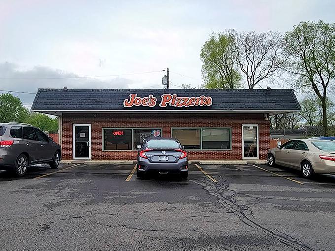 The unassuming brick exterior of Joe's Pizzeria stands as a beacon of hope for the pizza-deprived, its retro sign promising delicious salvation within. 