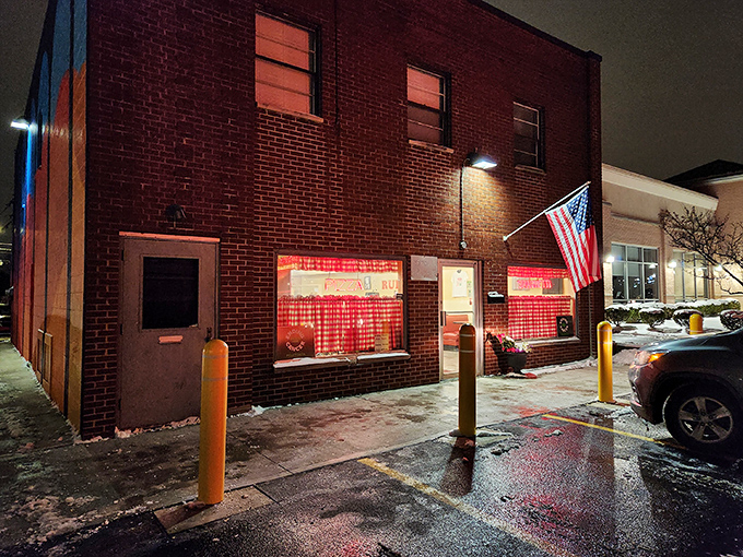 The classic red-and-white checkered curtains and neon signs aren't trendy design choices—they're time machines to when pizza joints were neighborhood institutions, not Instagram backdrops.