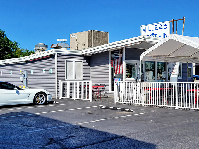 The unassuming blue-gray exterior of Miller's Drive-In stands as a time capsule of Americana, where culinary memories are made one scoop at a time. 