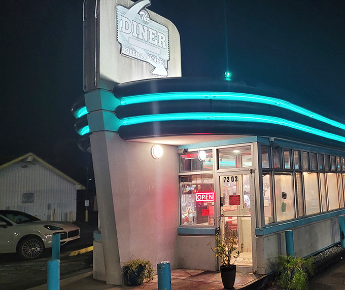 The neon glow of The Palace Diner beckons like a lighthouse for hungry souls. That turquoise trim against the night sky is pure roadside Americana magic.