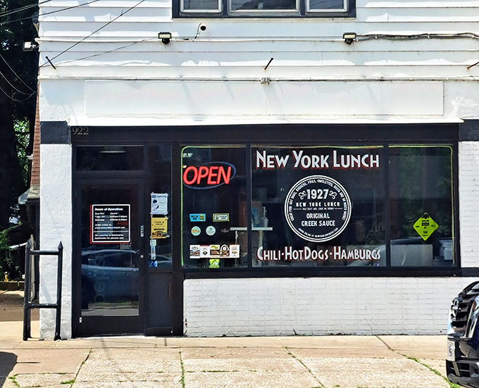 The unassuming storefront of New York Lunch belies the culinary treasures within. Classic neon signage promises simple pleasures done right.