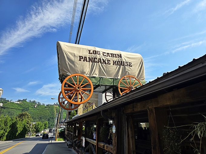 The iconic covered wagon perched atop Log Cabin Pancake House announces your arrival at breakfast nirvana. Gatlinburg's skyline and mountains create the perfect backdrop.