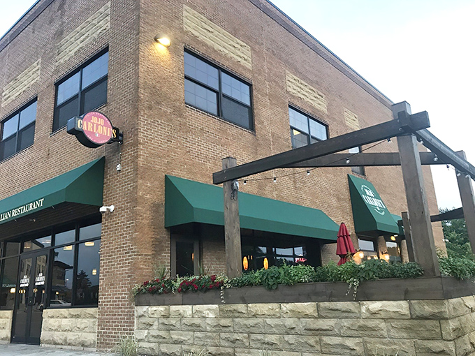 The brick exterior of Jo Jo Carloni's with its signature green awnings stands like a culinary lighthouse in Berea, beckoning hungry travelers to authentic Italian shores.