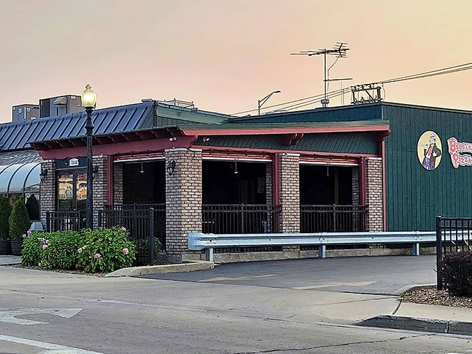 The green-roofed brick facade of Beggars Pizza stands like a beacon of comfort food in Blue Island, promising delicious possibilities within those welcoming walls.