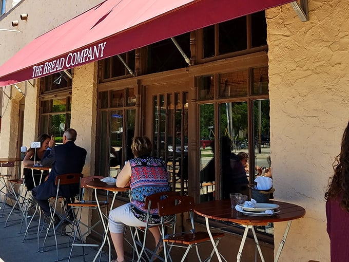 The classic black awning and textured white exterior of The Bread Company beckons like a European postcard come to life in downtown Urbana.