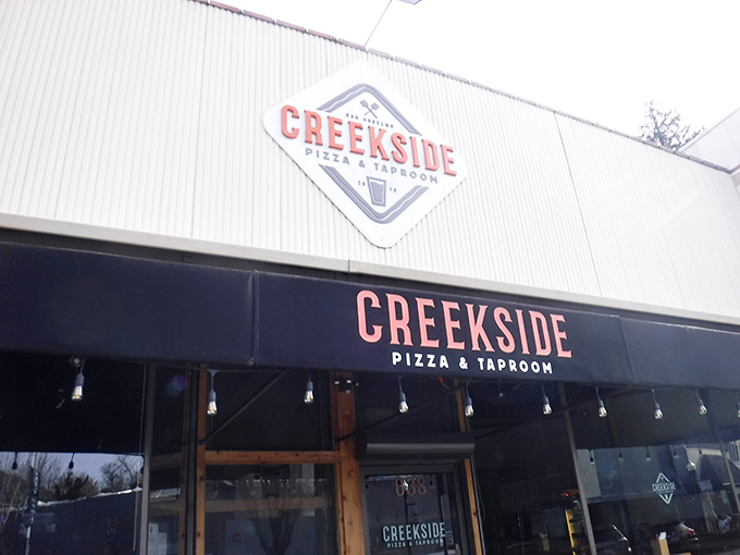 The unassuming exterior of Creekside Pizza & Taproom &ndash; proof that culinary treasures often hide behind modest facades.