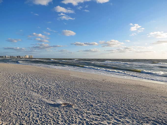 The pristine shoreline stretches toward infinity, where sky meets Gulf in a watercolor masterpiece. Mother Nature showing off her best work.