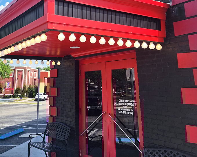 The iconic red and black exterior of Boston Lobster Feast stands out like a lighthouse beckoning seafood lovers to safe harbor. Those marquee lights aren't just for show!