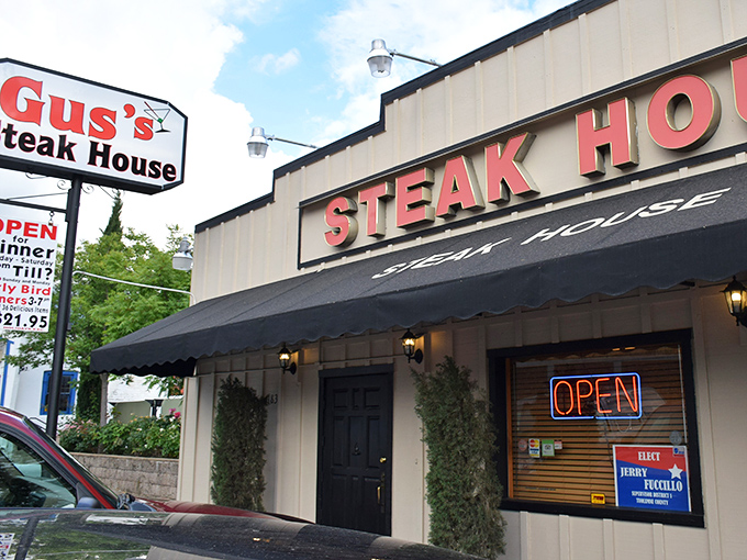 The classic red lettering against cream siding isn't just signage&mdash;it's a beacon of hope for hungry travelers. Gus's Steakhouse promises what we all secretly crave: simplicity done spectacularly.