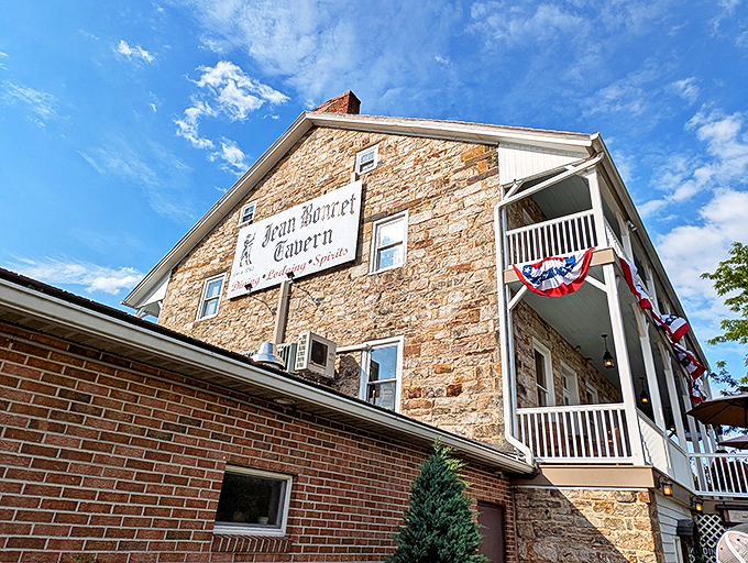 Stone walls that have witnessed centuries of American history stand proudly under Pennsylvania skies. The Jean Bonnet Tavern's exterior is a postcard from the past.