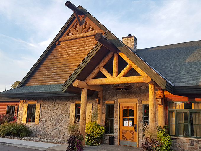 Like a woodland mirage in suburban Michigan, Big Bear Lodge's timber-framed entrance promises rustic comfort before you even step inside.
