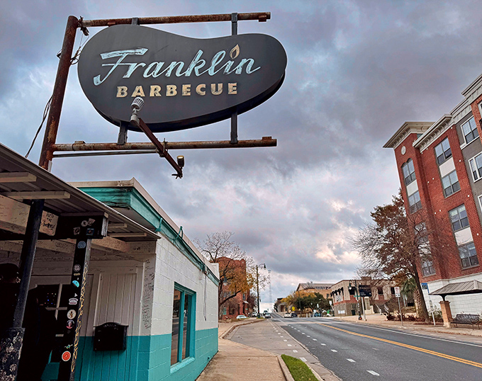 The unassuming turquoise exterior of Franklin Barbecue belies the culinary magic happening inside. Like a barbecue speakeasy, only the aroma gives away its secrets.