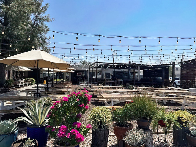 String lights dance overhead as white picnic tables invite you to settle in for a feast. Arizona's perfect evening backdrop for serious BBQ business.