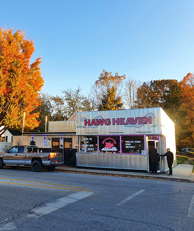 Fall foliage frames this humble BBQ shrine like nature's own Instagram filter. Hawg Heaven's corrugated exterior promises no frills&mdash;just thrills for your taste buds.
