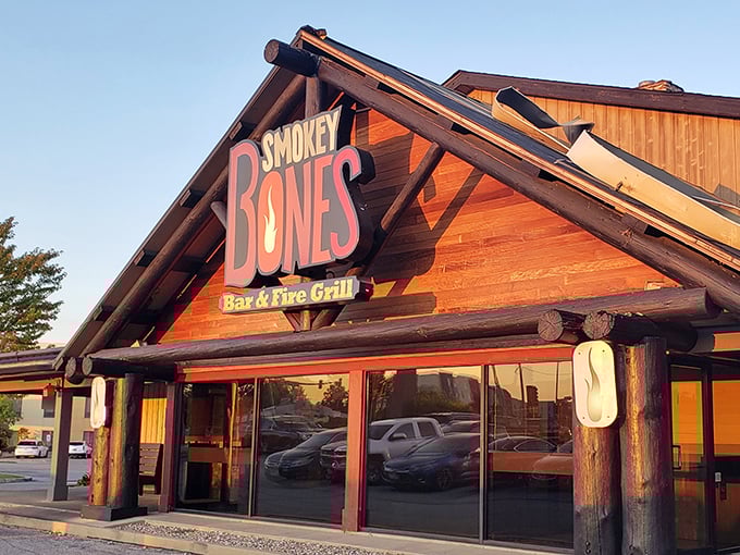 The rustic log cabin exterior beckons like a barbecue mirage in the prairie landscape. This isn't just a restaurant&mdash;it's a smoke signal to hungry travelers.