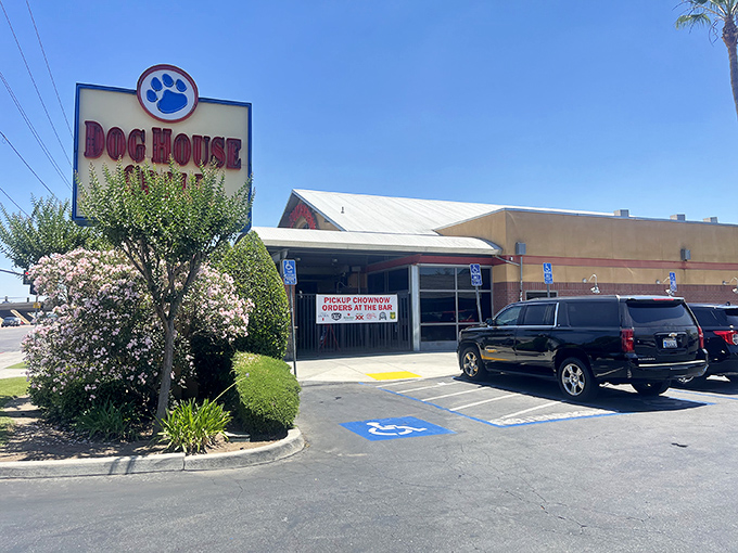 The iconic blue paw print sign welcomes hungry pilgrims to Dog House Grill, Fresno's temple of smoke and flame.