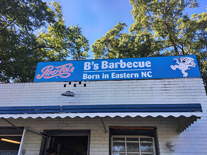 The unassuming white brick exterior of B's Barbecue stands like a barbecue shrine in Greenville, complete with its iconic blue sign declaring Eastern NC roots.