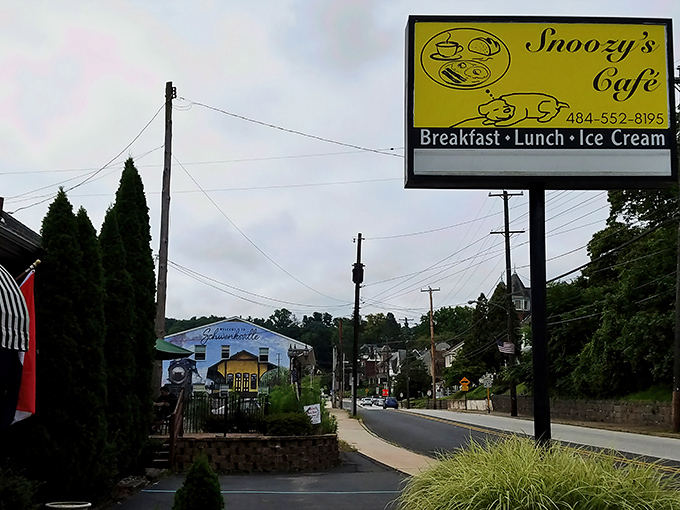 The bright yellow sign beckons like a culinary lighthouse on Main Street, promising the holy trinity of small-town comfort: breakfast, lunch, and that all-important ice cream finale.