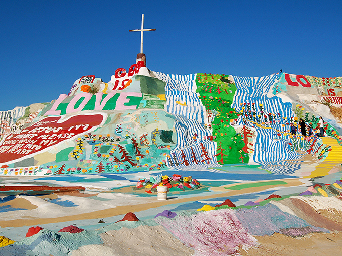 Sunset transforms Salvation Mountain into a psychedelic dream, where the desert sky and painted hillside compete for which can be more dramatically colorful.