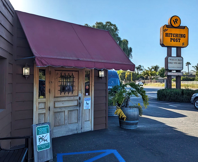 The iconic red awning and rustic wooden entrance of Hitching Post 2 stands as a beacon for steak lovers throughout California's wine country.