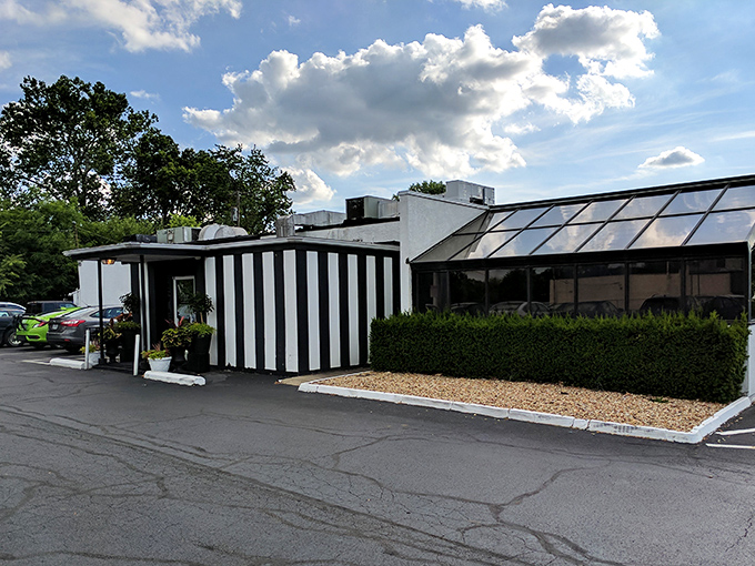 The iconic black and white striped exterior of The Top Steak House stands as Columbus's temple to timeless dining, promising carnivorous delights within.