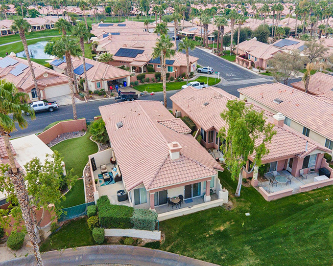 Terra cotta rooftops stretch like a warm blanket across Palm Desert Country Club, where retirement dreams don't require a millionaire's bank account.