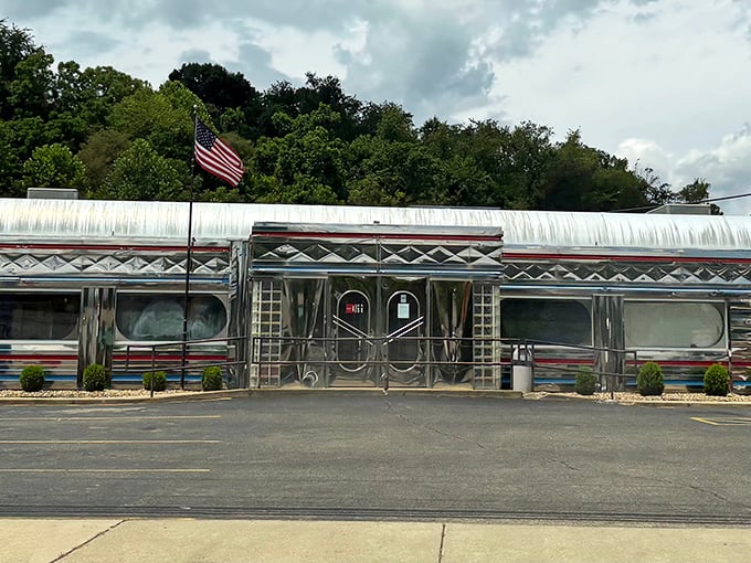 The gleaming stainless steel exterior of Diner 23 stands like a time capsule on wheels, permanently parked in Waverly with an American flag proudly waving hello.