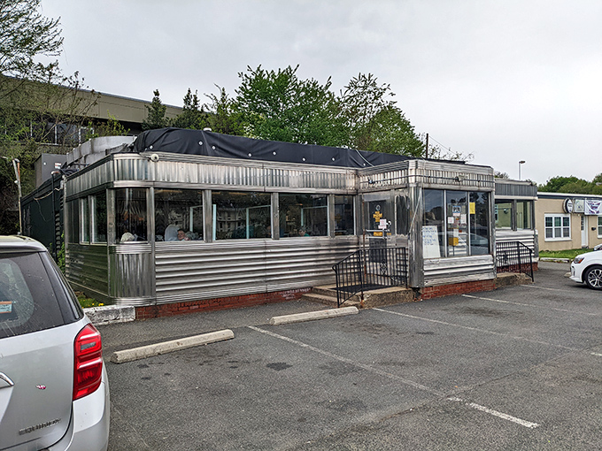 The gleaming stainless steel exterior of Frost Diner stands like a time capsule on wheels, permanently parked in the heart of Warrenton, Virginia.