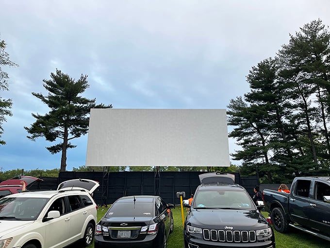 Cars line up at dusk, anticipation building as the massive screen awaits the night's feature. A perfect summer evening under Ohio stars.