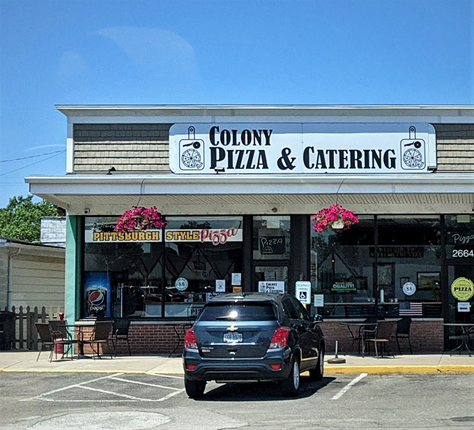 Colony Pizza's unassuming storefront hides culinary treasures within. Those hanging flower baskets aren't just for show—they're a welcome sign that good things await inside.