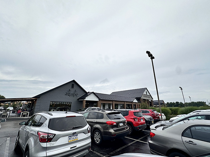 The modern farmhouse exterior of Agapē Cafe & Grille stands proudly against Pennsylvania's blue skies, promising culinary adventures within those charcoal-gray walls.