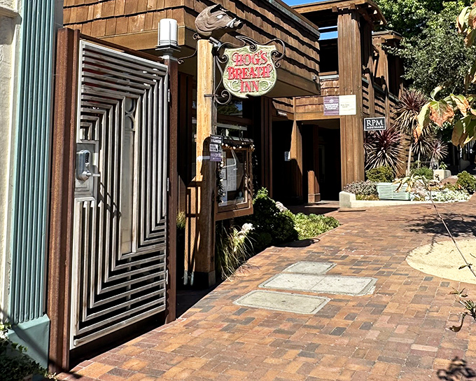 The rustic wooden exterior of Hog's Breath Inn beckons like an old friend, its distinctive sign promising comfort and satisfaction in charming Carmel-By-The-Sea.
