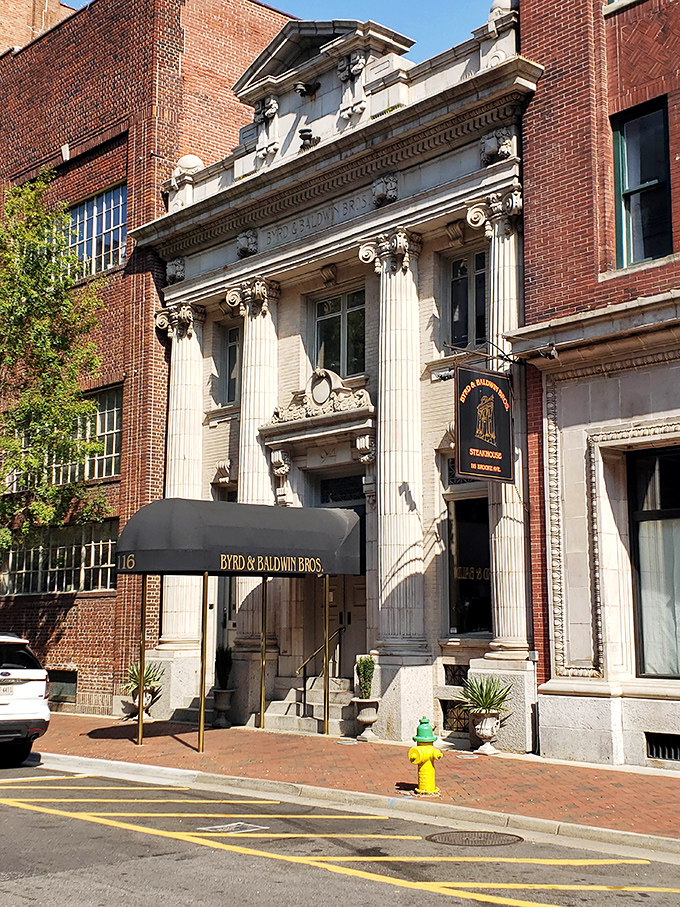 The grand neoclassical fa&ccedil;ade of Byrd & Baldwin Bros Steakhouse glows like a culinary temple at night, beckoning hungry pilgrims with promises of carnivorous delights.