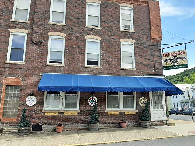 The brick facade of Deitsch Eck, with its vibrant blue awning and traditional hex signs, stands as a beacon of Pennsylvania Dutch authenticity in Lenhartsville.