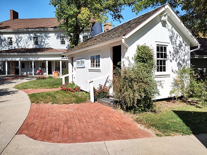The charming white exterior of The Barn Restaurant's gift shop welcomes visitors with brick pathways and colorful flower beds&mdash;a prelude to the comfort food paradise within.