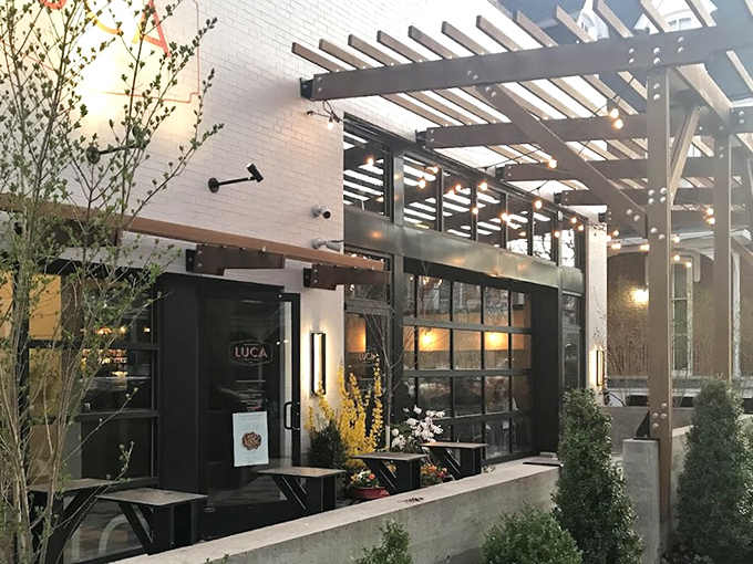 LUCA's pristine white exterior whispers elegance rather than shouting it, with that wooden pergola promising Italian magic before you even step inside.