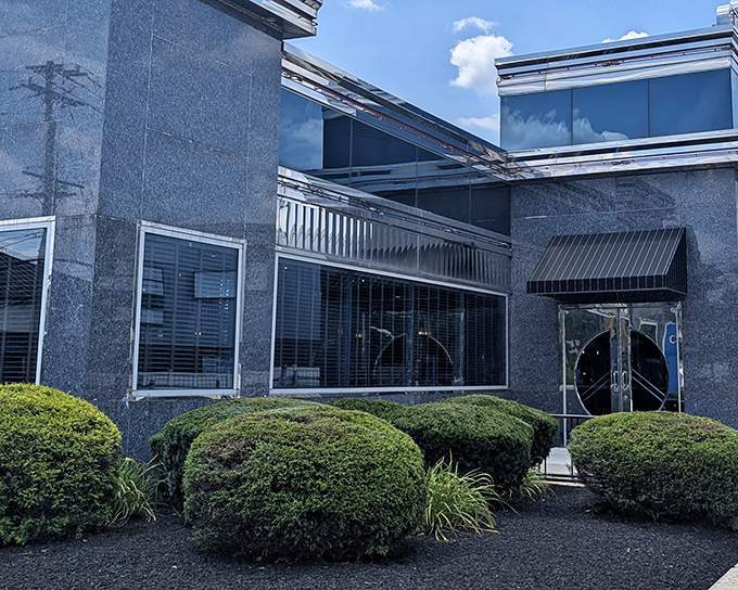 The distinctive blue-gray exterior of Collegeville Diner stands like a beacon for hungry travelers, promising comfort food salvation behind those welcoming double doors.