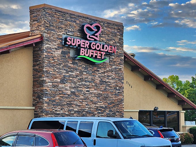 The stone facade of Super Golden Buffet beckons with its vibrant pink and green signage&mdash;like a neon promise of culinary abundance waiting inside.