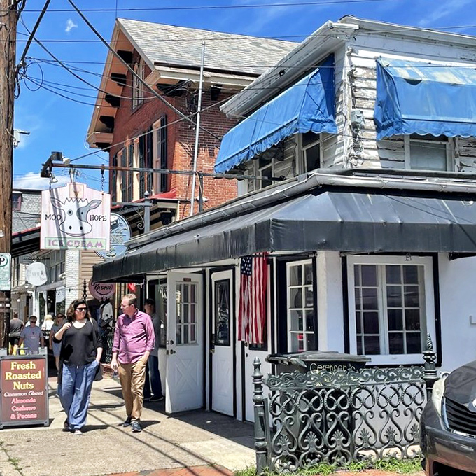The whimsical cow sign hanging above Moo Hope Ice Cream is like a beacon of dairy delight in New Hope's charming downtown.