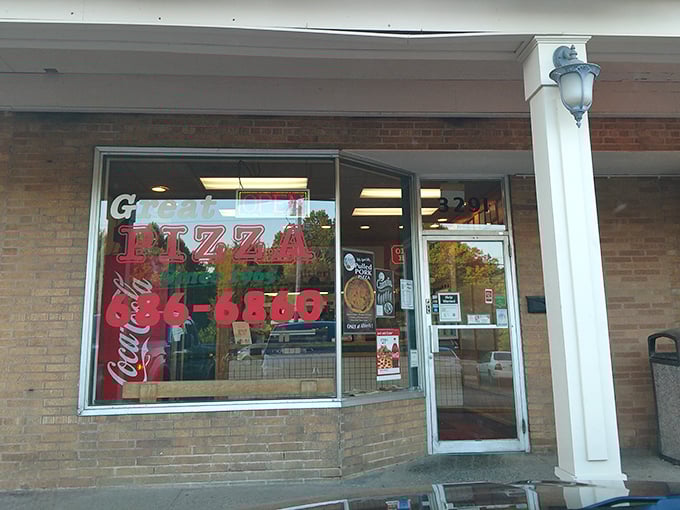 The iconic turquoise and pink sign beckons pizza lovers like a neon lighthouse guiding hungry sailors to the shores of flavor paradise.