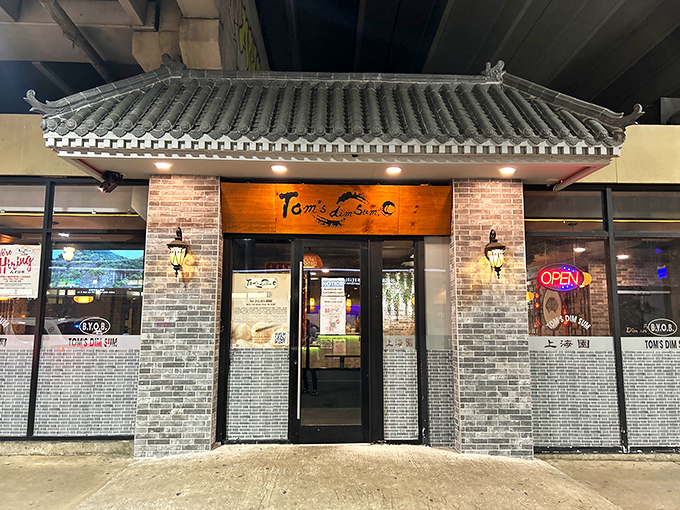 The unassuming wooden sign above Tom's Dim Sum belies the culinary treasures within. Like finding a rare vinyl in a record store, the joy is in the discovery.