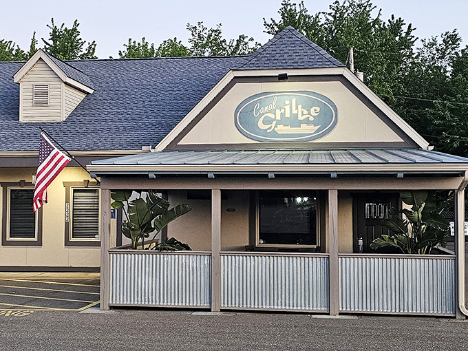 The welcoming facade of Canal Grille beckons like an old friend, complete with corrugated metal porch and that iconic blue sign promising culinary delights within.