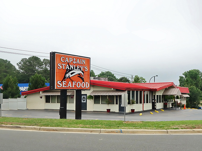 The iconic red roof and bold signage of Captain Stanley's stands as a beacon to seafood lovers, promising no-frills deliciousness inside.