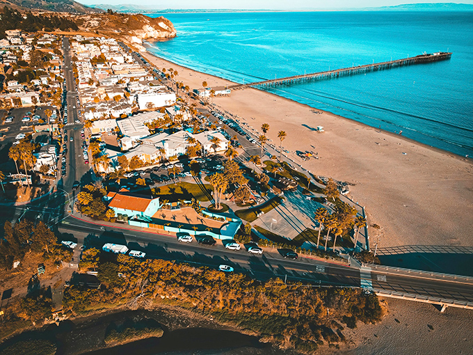 Aerial dreams come true: Avila Beach unfolds like a perfect postcard, with its golden crescent shoreline and that impossibly blue Pacific stretching to the horizon.