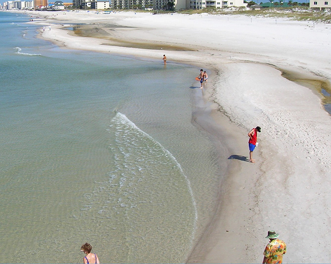 Sugar-white sands stretch for miles along Panama City Beach, where high-rises meet emerald waters in a dance of affordable luxury and natural splendor.