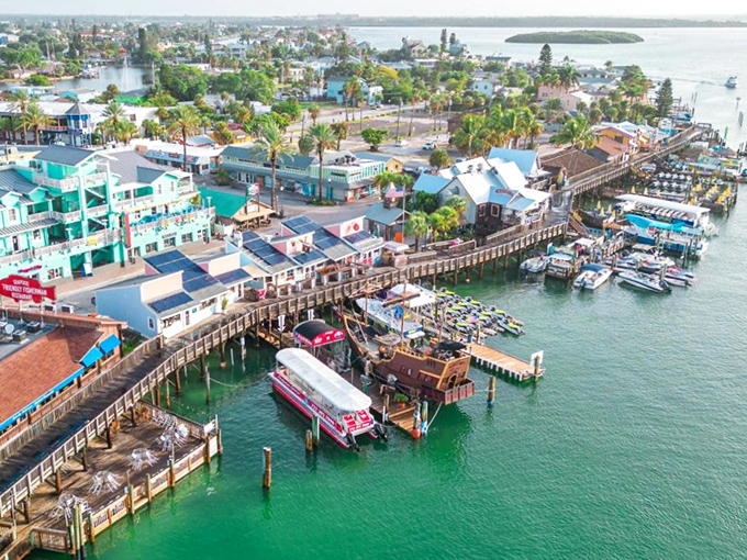 The weathered wooden boardwalk stretches into the distance, flanked by colorful shops that beckon like old friends waiting to share their stories.
