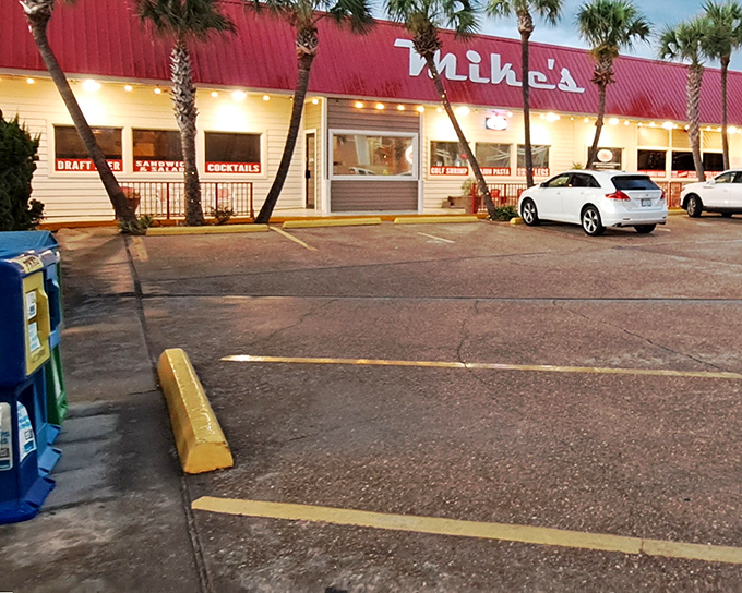 Mike's distinctive red roof and palm trees stand like beacons for seafood lovers, promising treasures that the unassuming exterior only hints at.