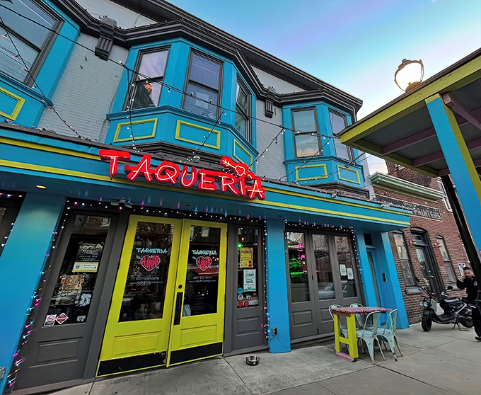 That neon red "TAQUERIA" sign glowing against Philadelphia's twilight sky promises serious flavor adventures ahead.