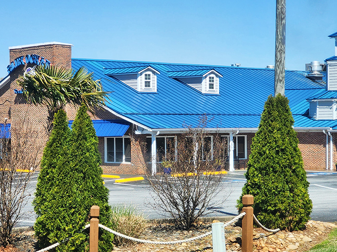 That iconic blue roof beckons like a lighthouse for hungry seafood lovers, promising maritime delights in landlocked Clinton.