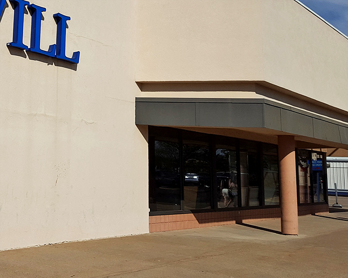 The blue Goodwill sign beckons like a lighthouse to bargain hunters. This unassuming exterior hides a treasure trove of possibilities within.